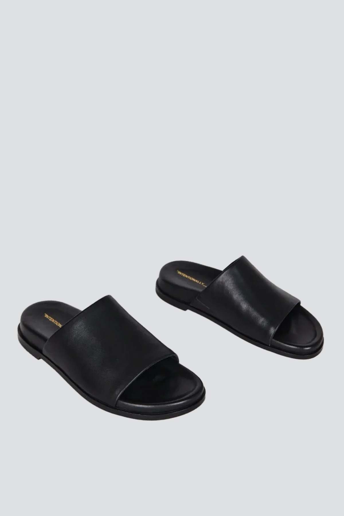 "INTENTIONALLY __________." Black Pippy Slip On Sandal - Black | Garmentory