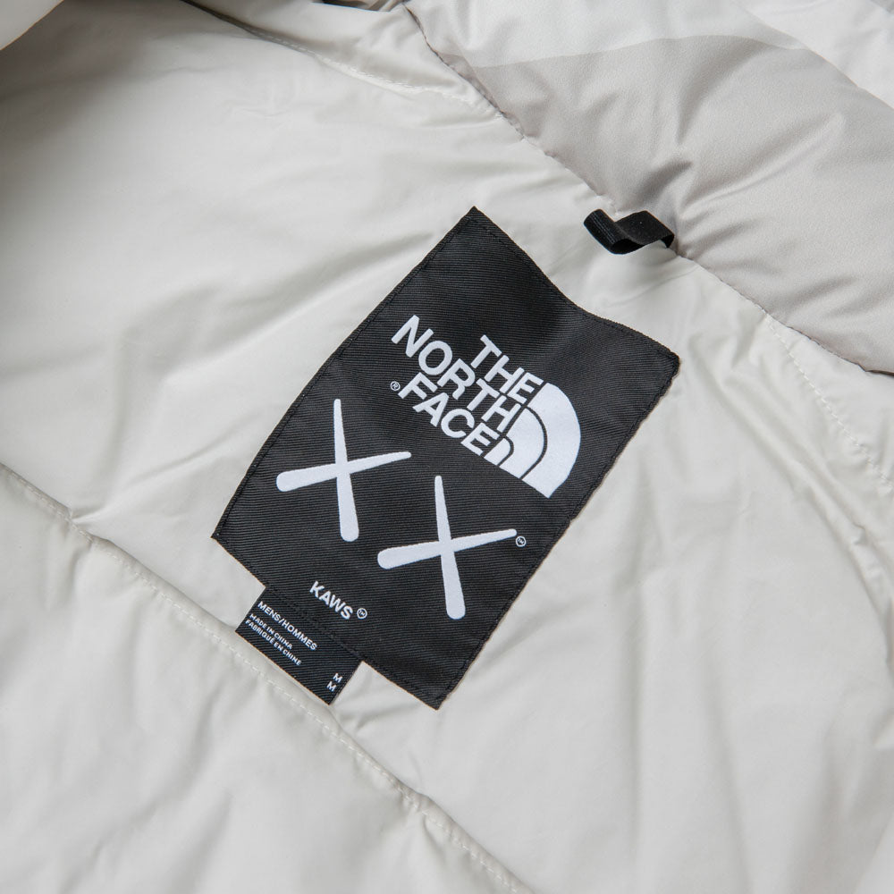 The North Face x KAWS Retro 1996 Nuptse Jacket - Moonlight Ivory ...