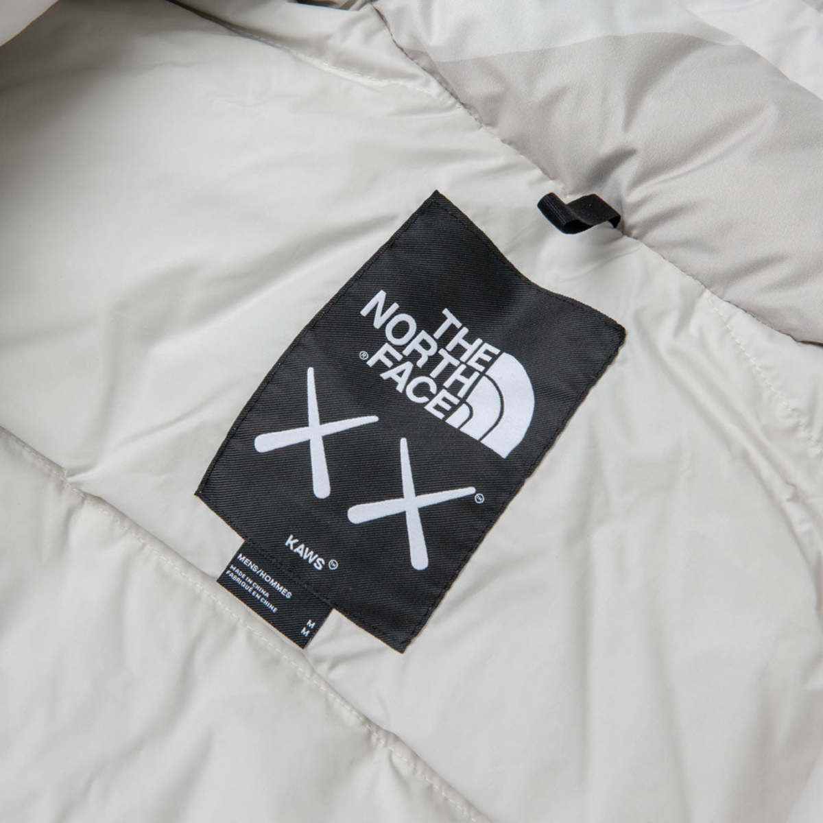 The North Face x KAWS Retro 1996 Nuptse Jacket - Moonlight Ivory ...