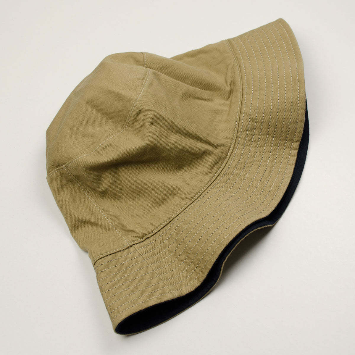 cableami Loose Light Chino Reversible Bucket Hat - Navy/Beige | Garmentory