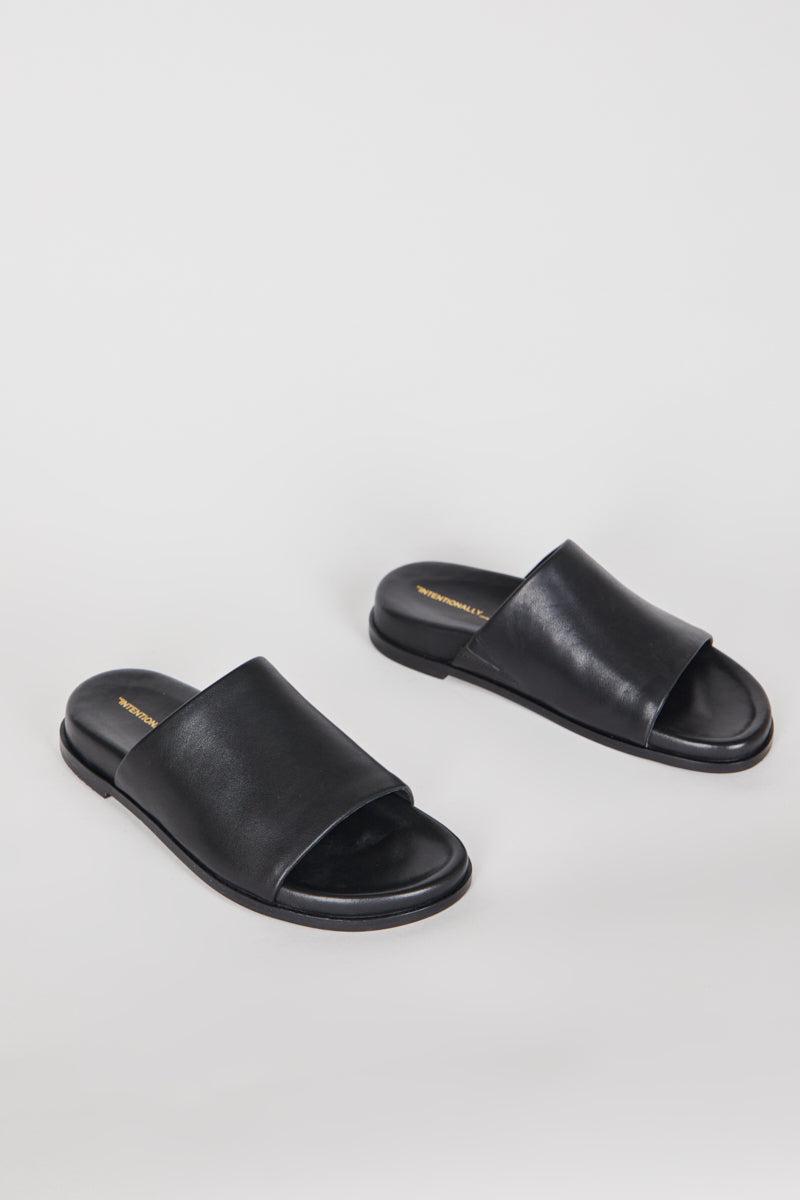 "INTENTIONALLY __________." Pippy Slip On Sandal - Black | Garmentory