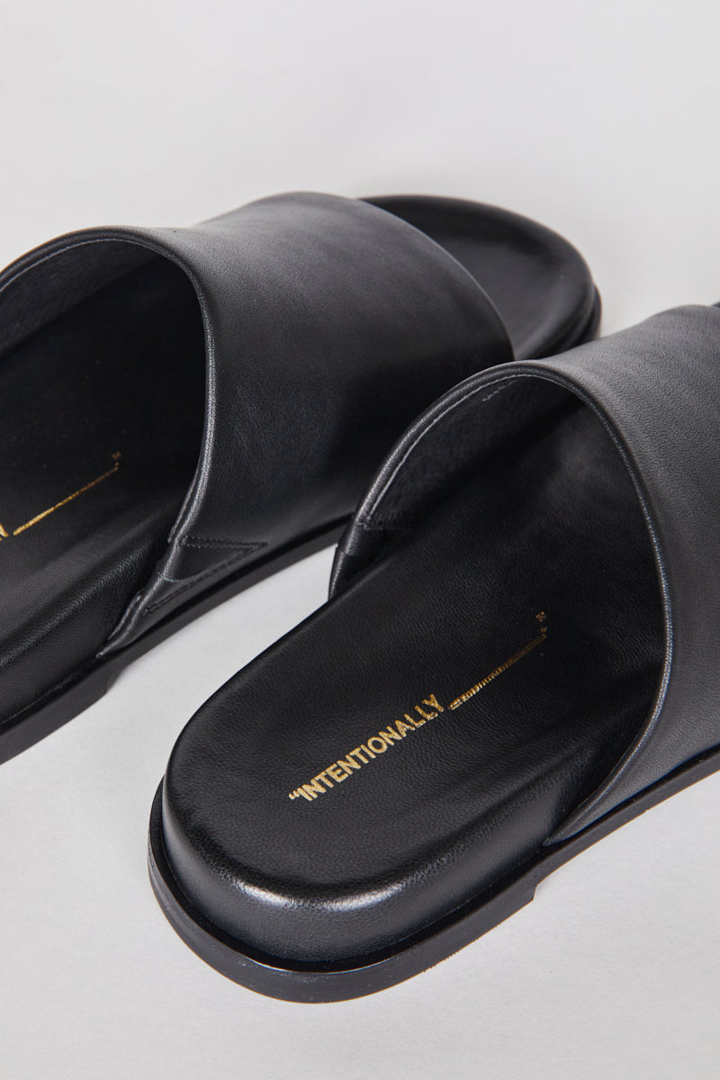 "INTENTIONALLY __________." Pippy Slip On Sandal - Black | Garmentory