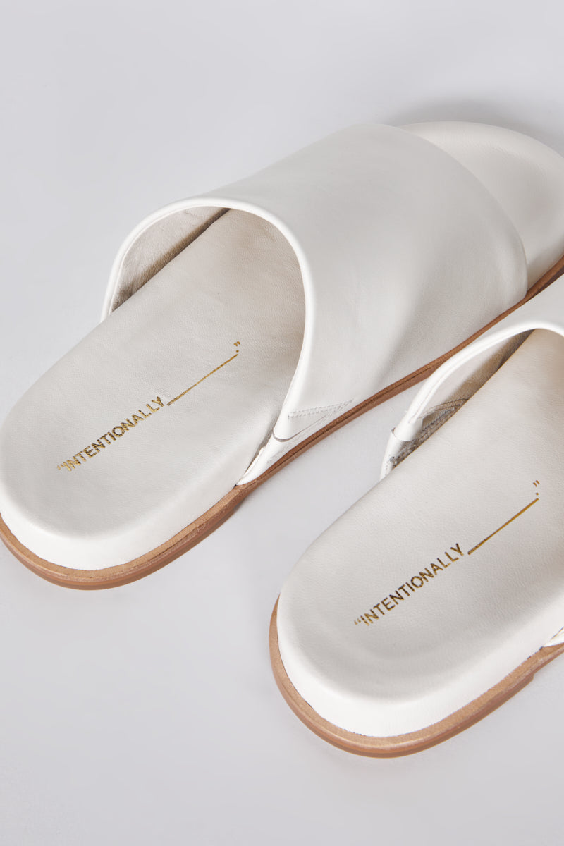 "INTENTIONALLY __________." Pippy Slip On Sandal - Black | Garmentory