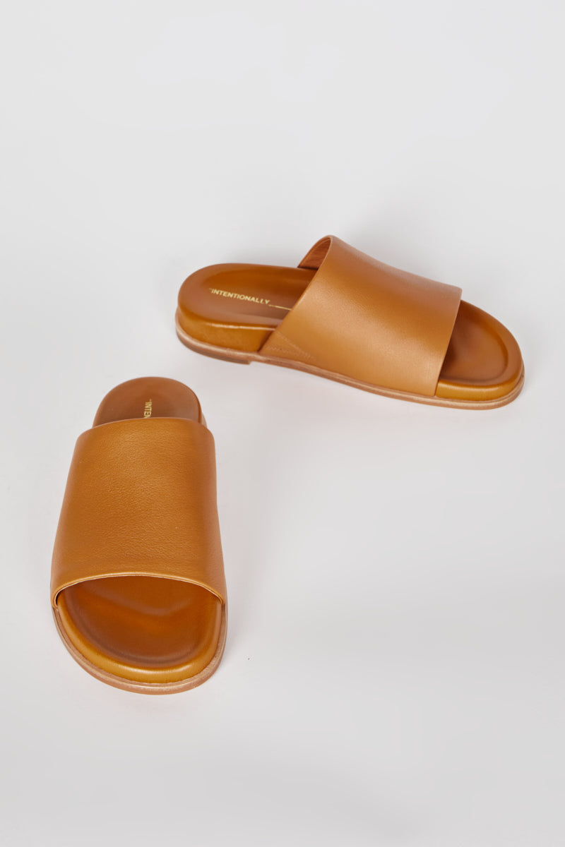 "INTENTIONALLY __________." Pippy Slip On Sandal - Black | Garmentory