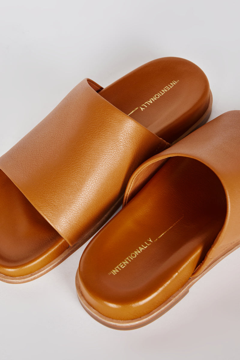"INTENTIONALLY __________." Pippy Slip On Sandal - Black | Garmentory